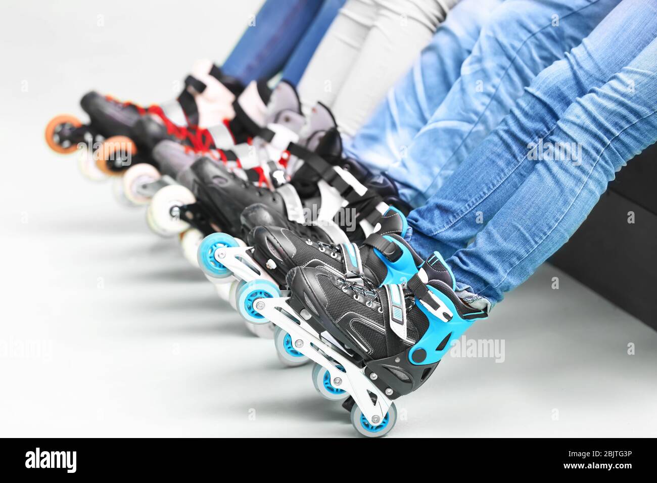 Group of people wearing roller skates on light background Stock Photo ...