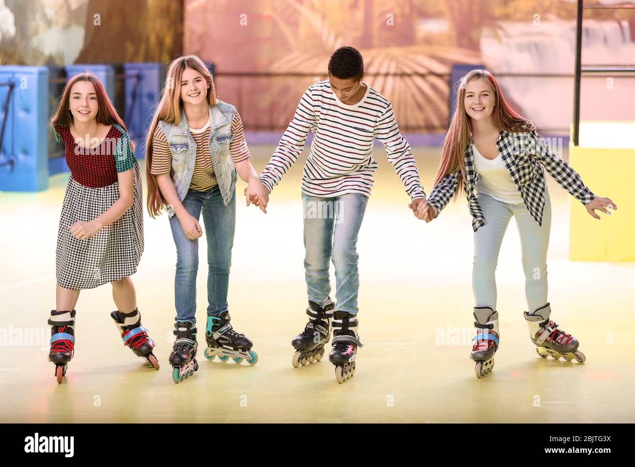 Group of teenagers at roller skating rink Stock Photo - Alamy