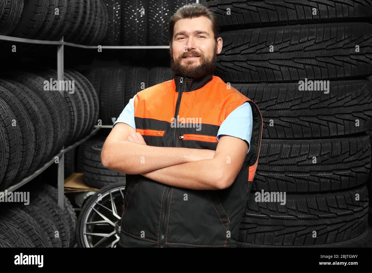 Male mechanic near tires hi-res stock photography and images - Alamy