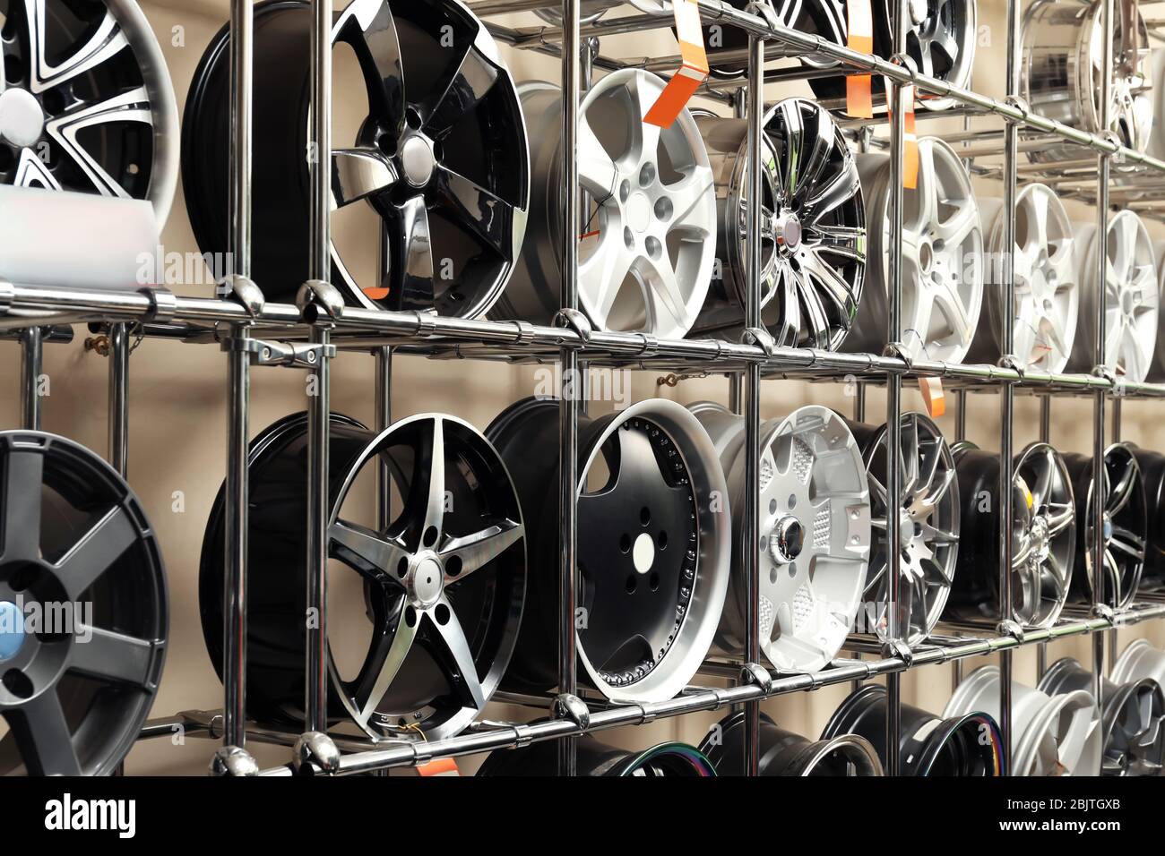 Rack with car wheels in automobile store Stock Photo - Alamy