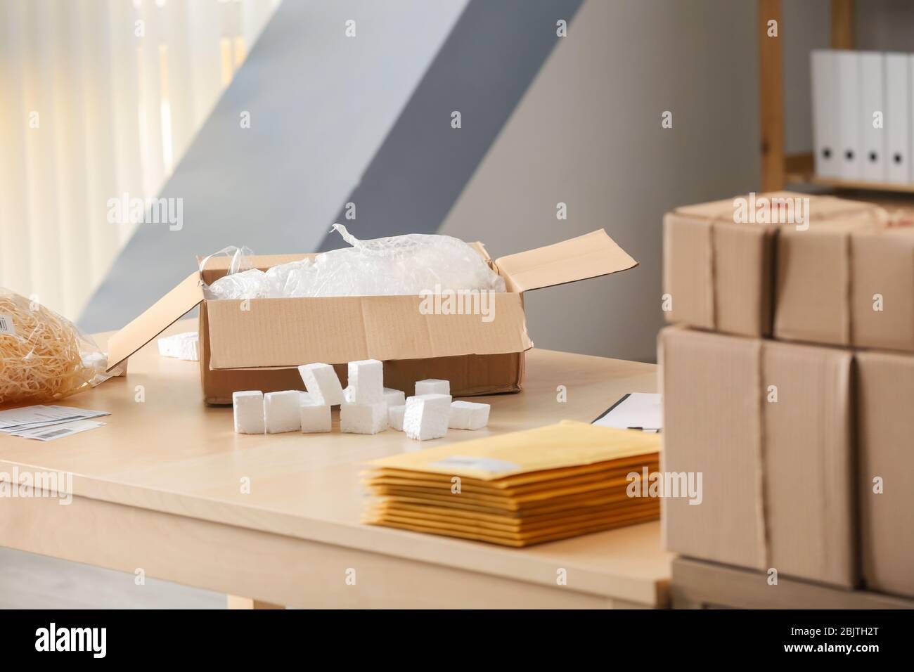 Open parcel box on table in home office Stock Photo - Alamy