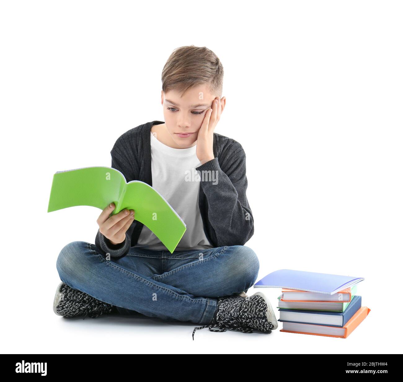 Teenager with exercise book studying on white background Stock Photo ...