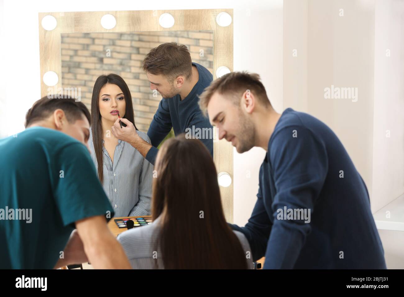 Professional makeup artist teaching trainee in salon. Apprenticeship ...