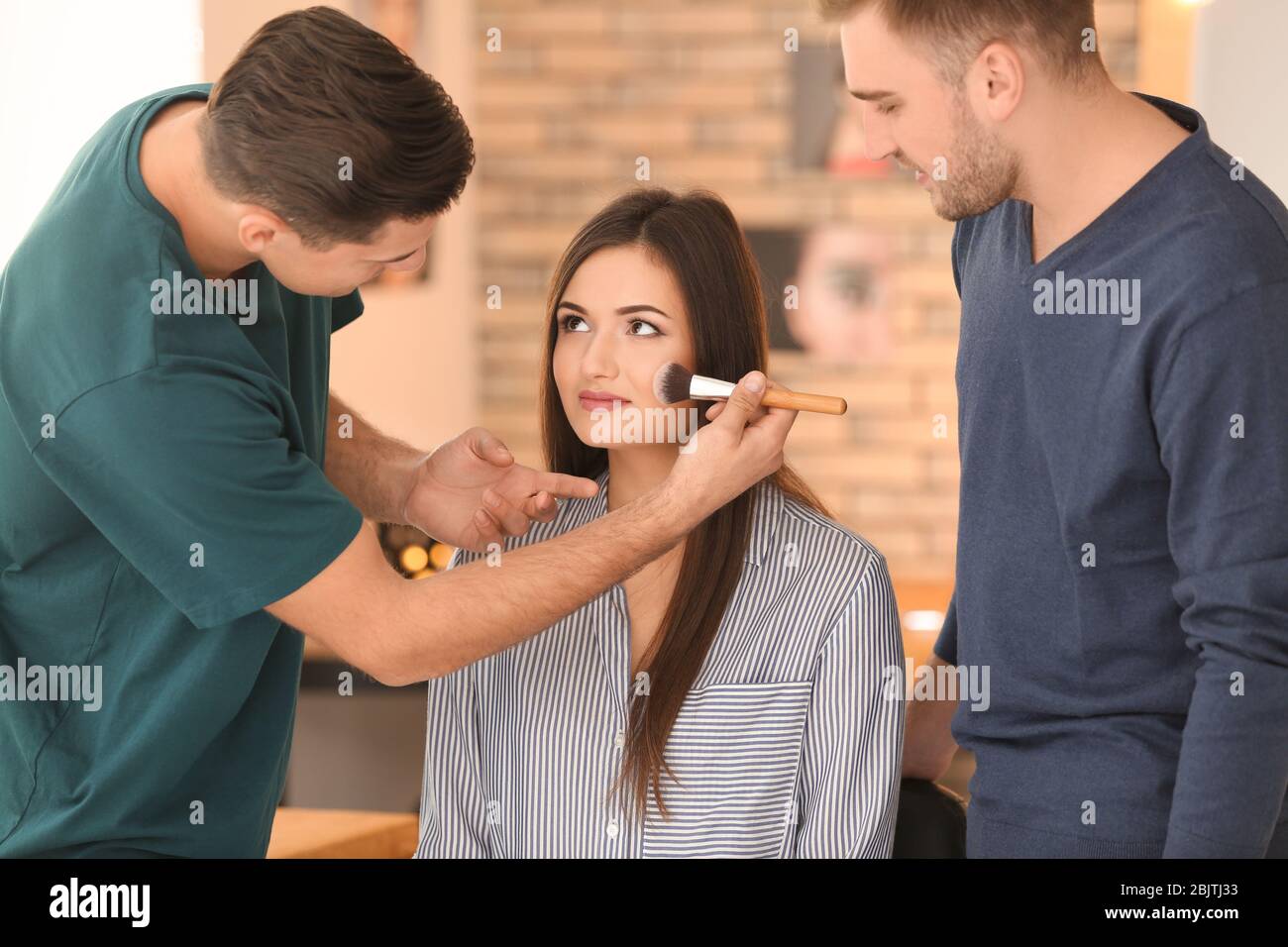 Professional makeup artist teaching trainee in salon. Apprenticeship ...