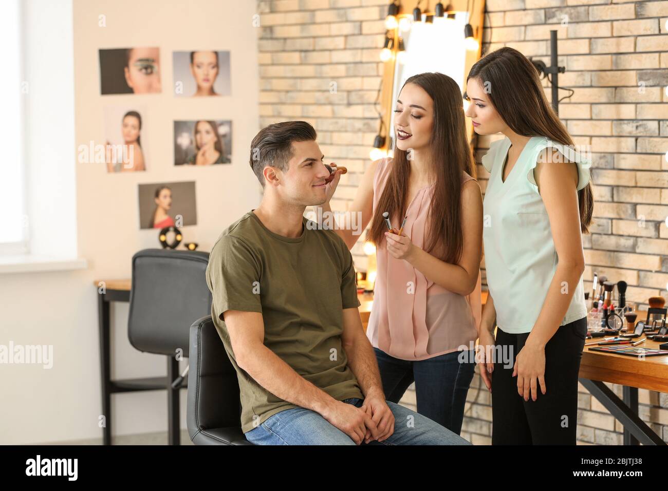 Professional makeup artist teaching trainee in salon. Apprenticeship ...