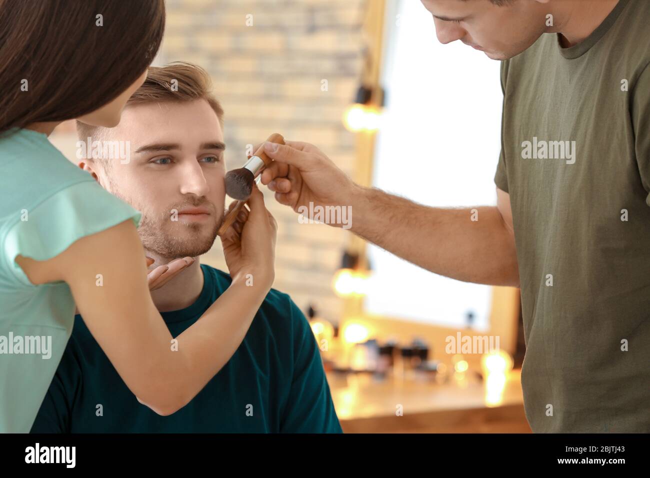 Professional makeup artist teaching trainee in salon. Apprenticeship ...