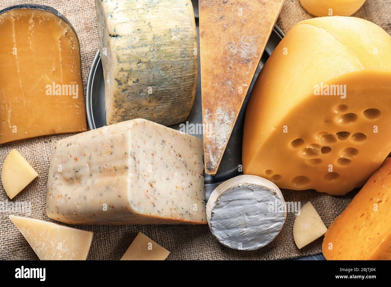 Different types of delicious cheese on sackcloth Stock Photo - Alamy
