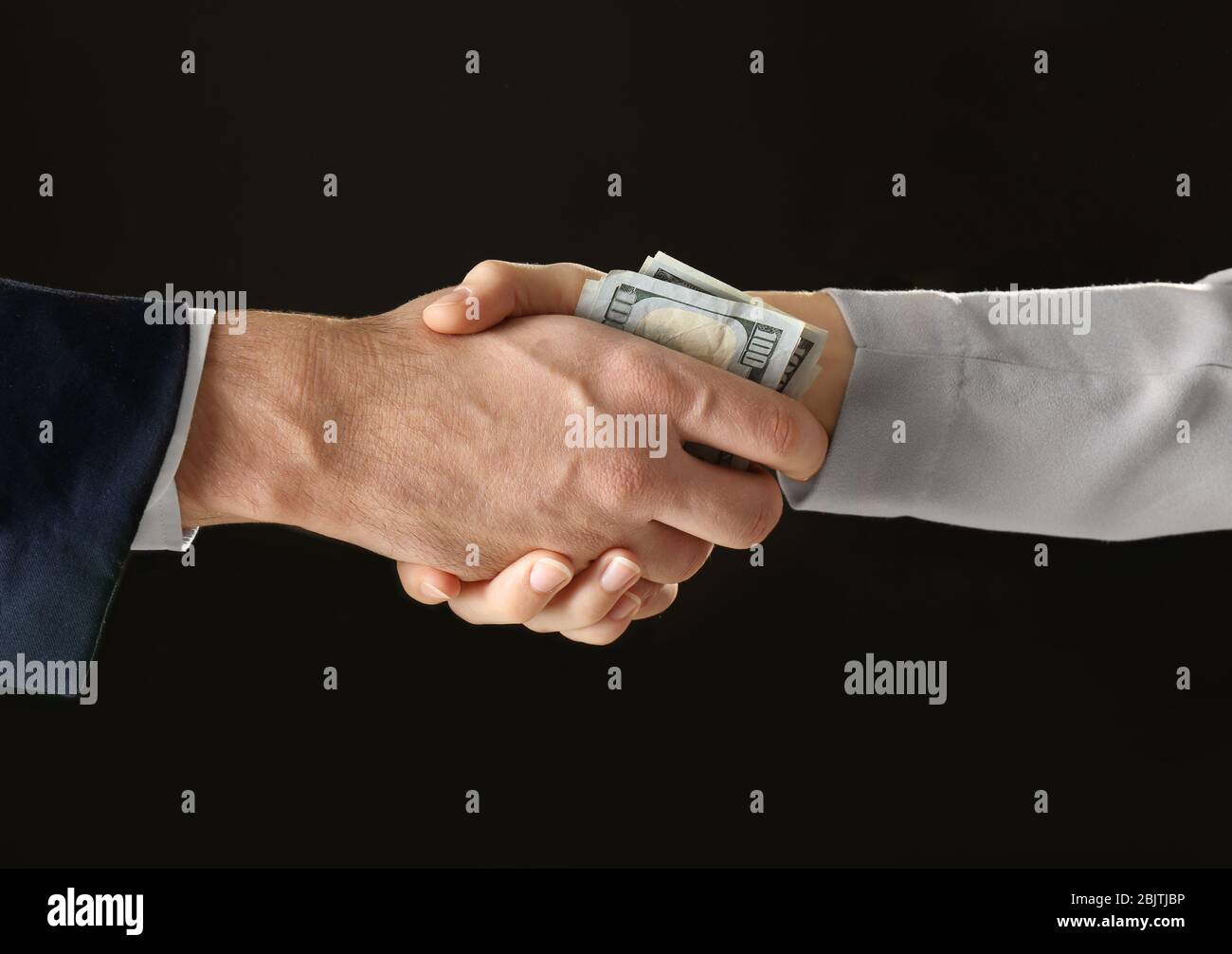 Businessman taking bribe from woman on black background Stock Photo - Alamy