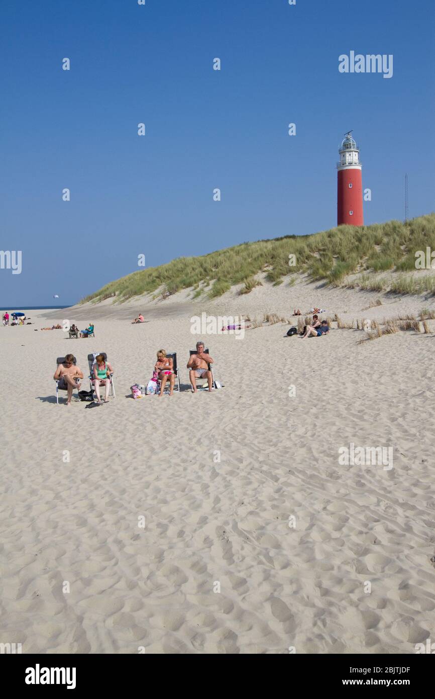Family is enjoying the sun on Texel beach, in the background the ...
