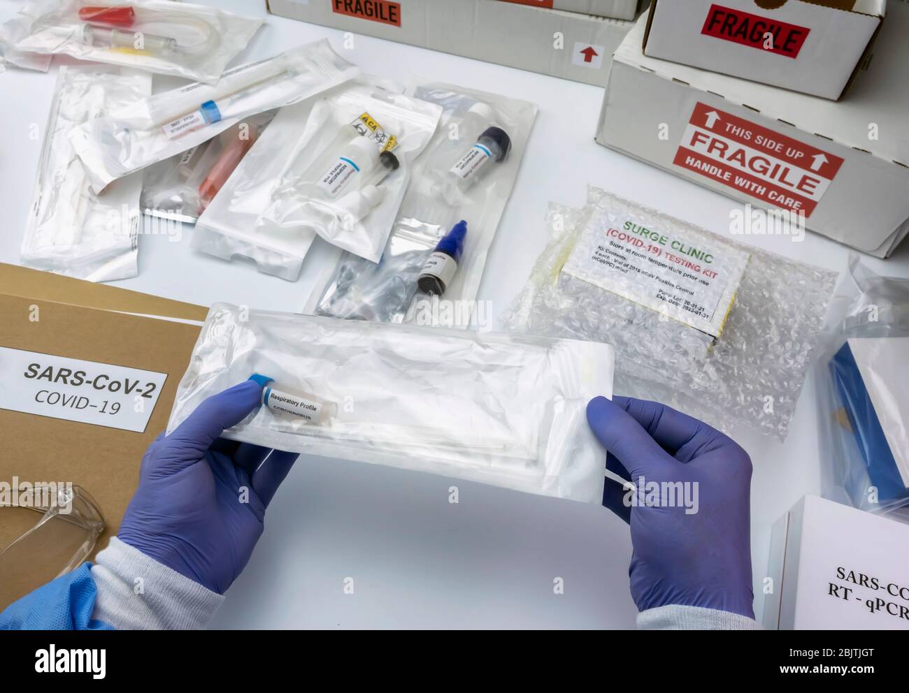 Nurse unpacking box with Covid-19 PCR kit in hospital warehouse ...