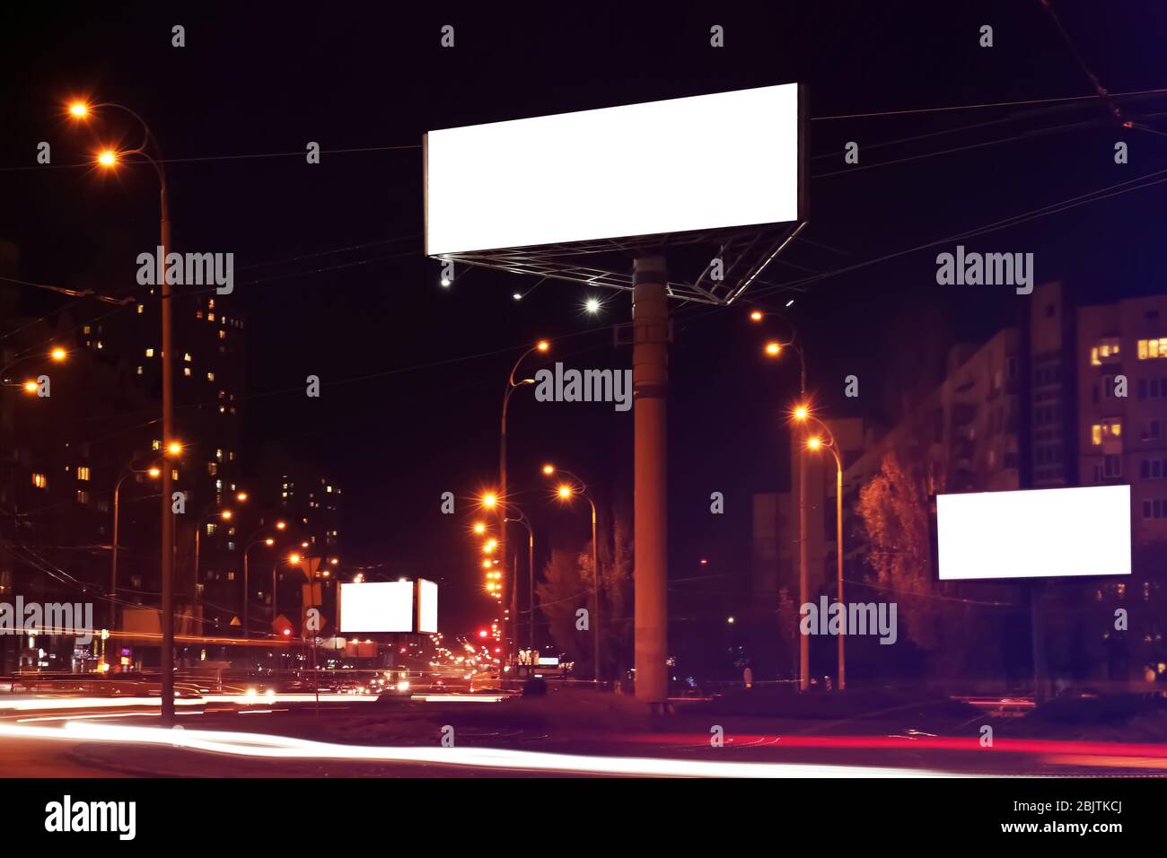 Blank advertising board on city street at night Stock Photo - Alamy