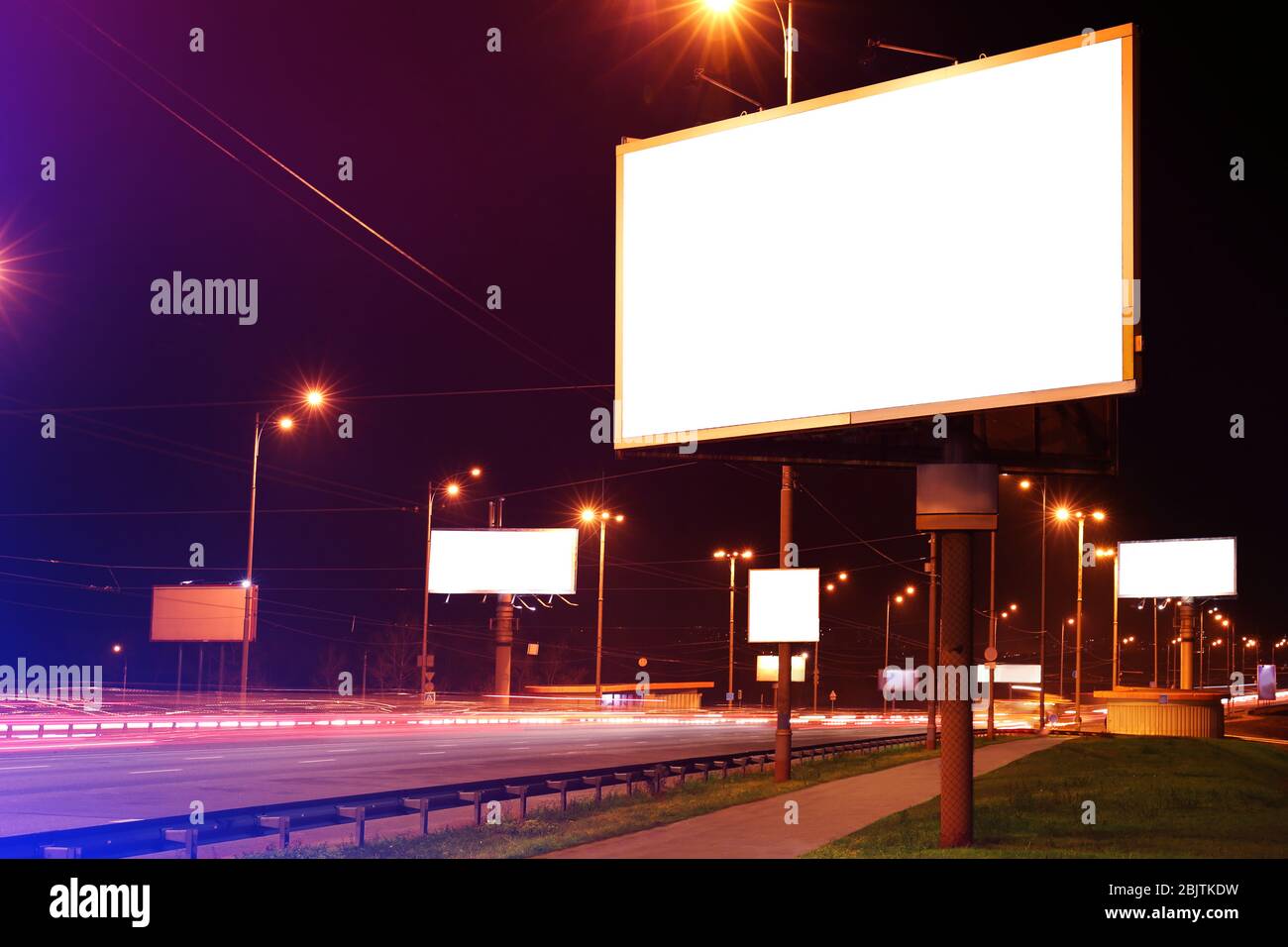 Blank advertising board on city street at night Stock Photo - Alamy