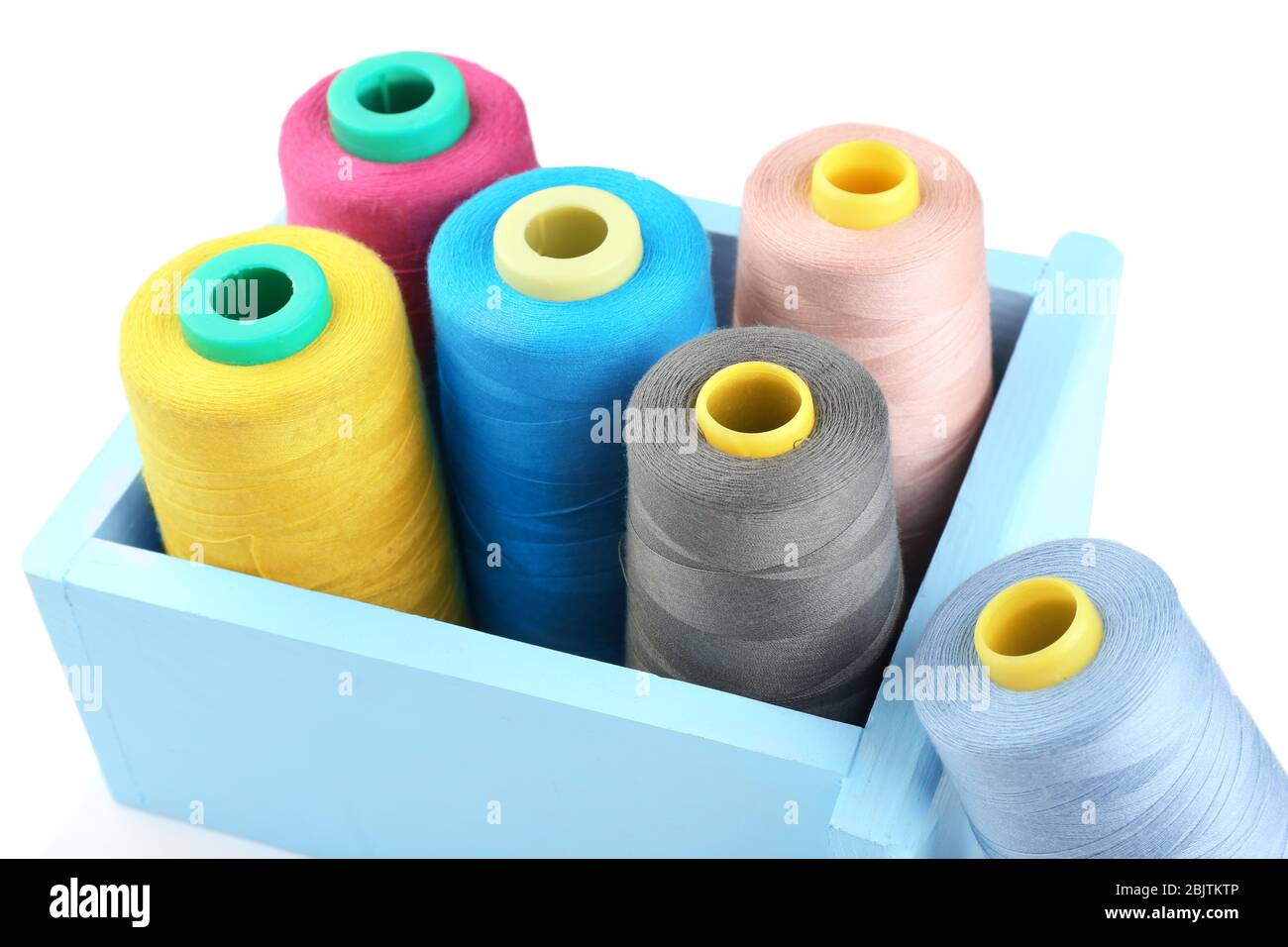 Set of color sewing threads in box on white background Stock Photo - Alamy