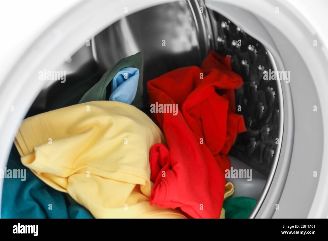Different clothes in washing machine for laundry, closeup Stock Photo ...