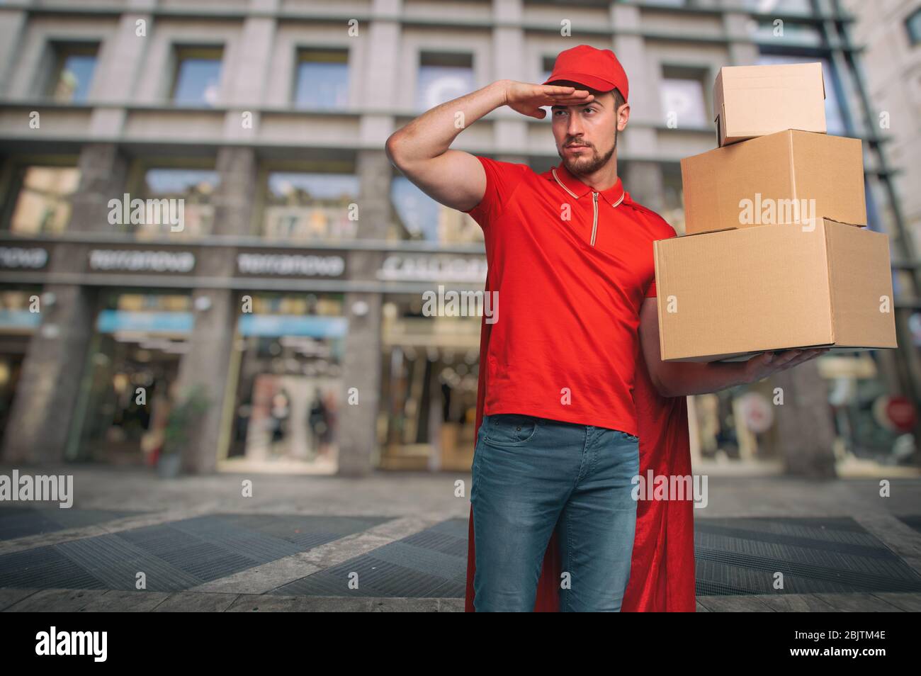 Red courier acts like a powerful superhero. Concept of success and ...
