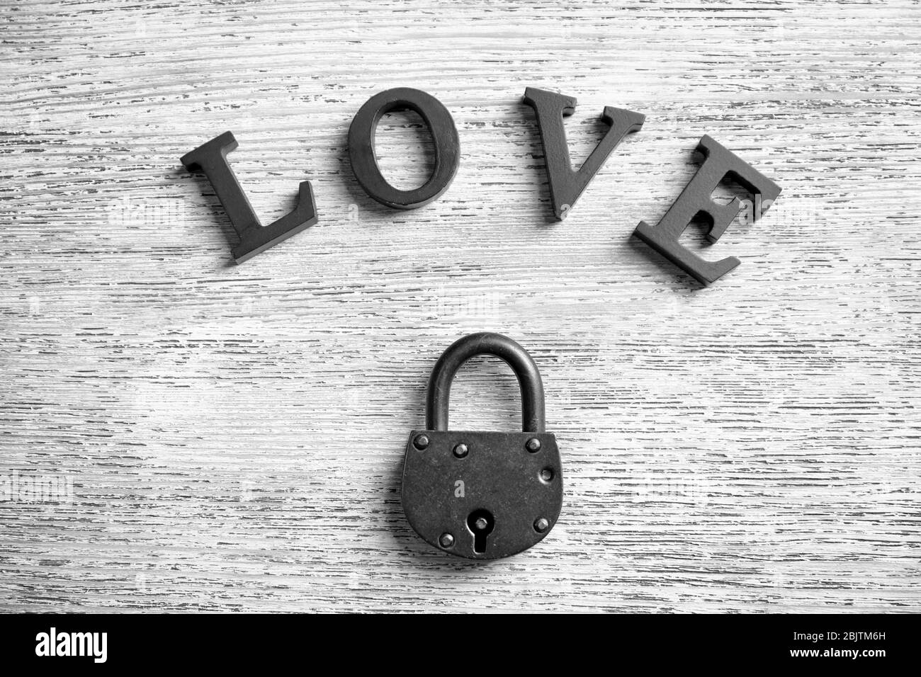Lock and word LOVE made of black letters on wooden background Stock ...