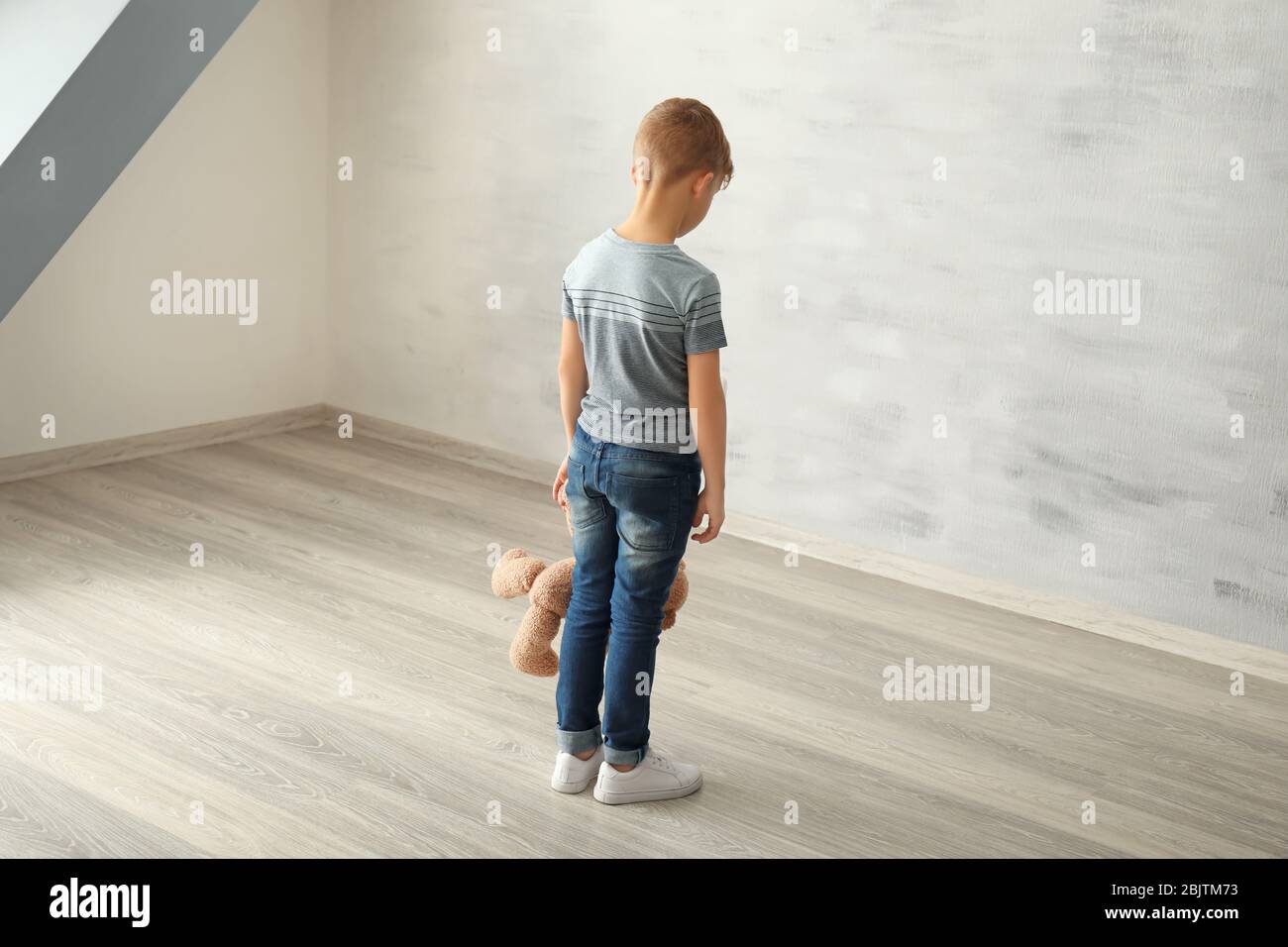 Little boy in empty room. Autism concept Stock Photo - Alamy