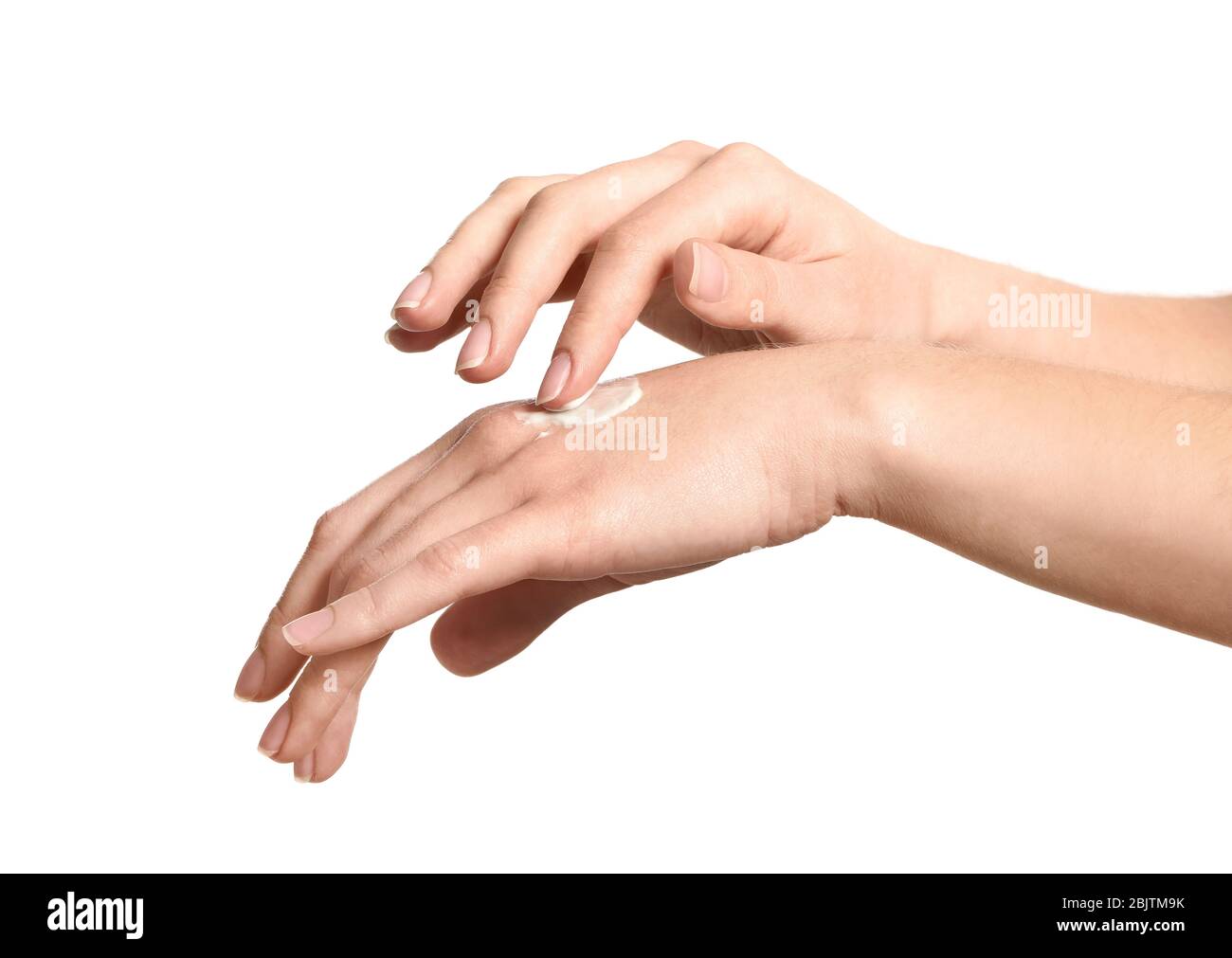 Young woman applying hand cream, on white background Stock Photo - Alamy