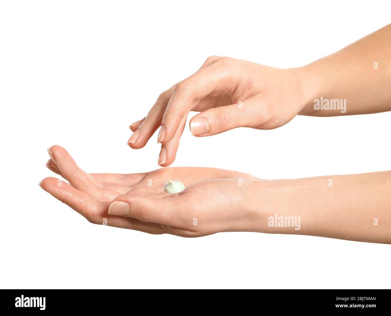 Young woman applying hand cream, on white background Stock Photo - Alamy