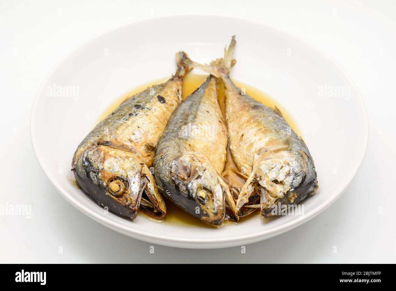 Fried mackerel on white plate. Deep fried fish Stock Photo - Alamy