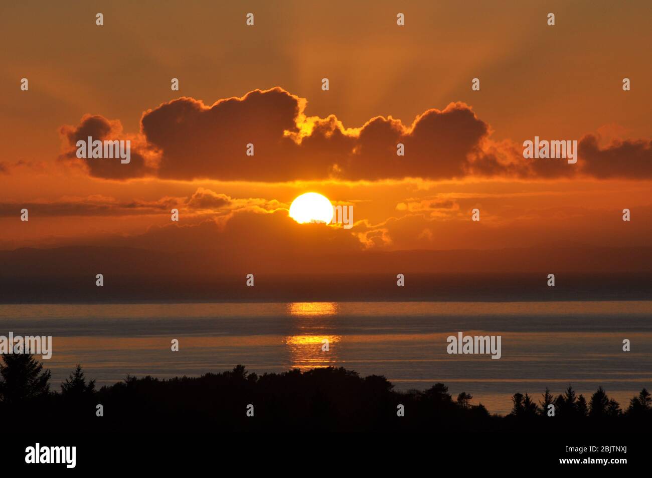 Sunset over the Isle of Arran from Culzean on the Scottish mainland ...