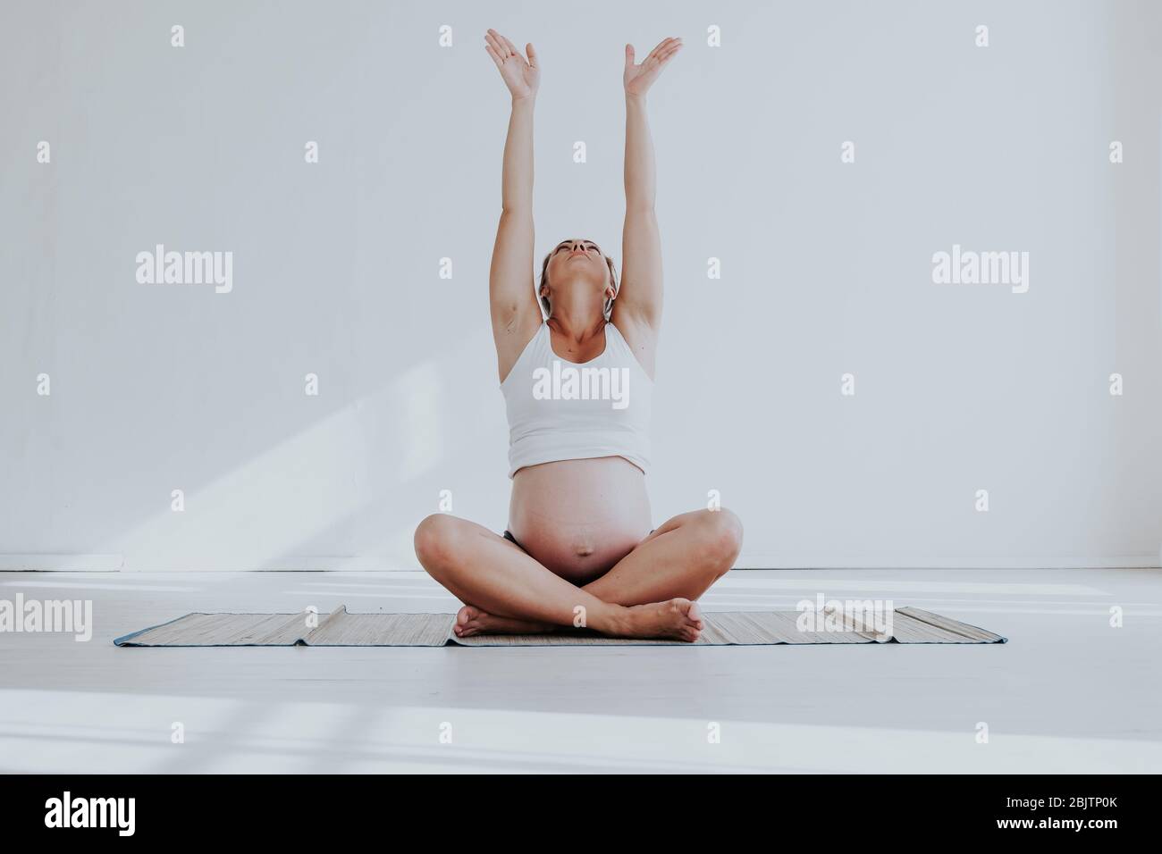 a pregnant woman is engaged in gymnastics and yoga Stock Photo - Alamy