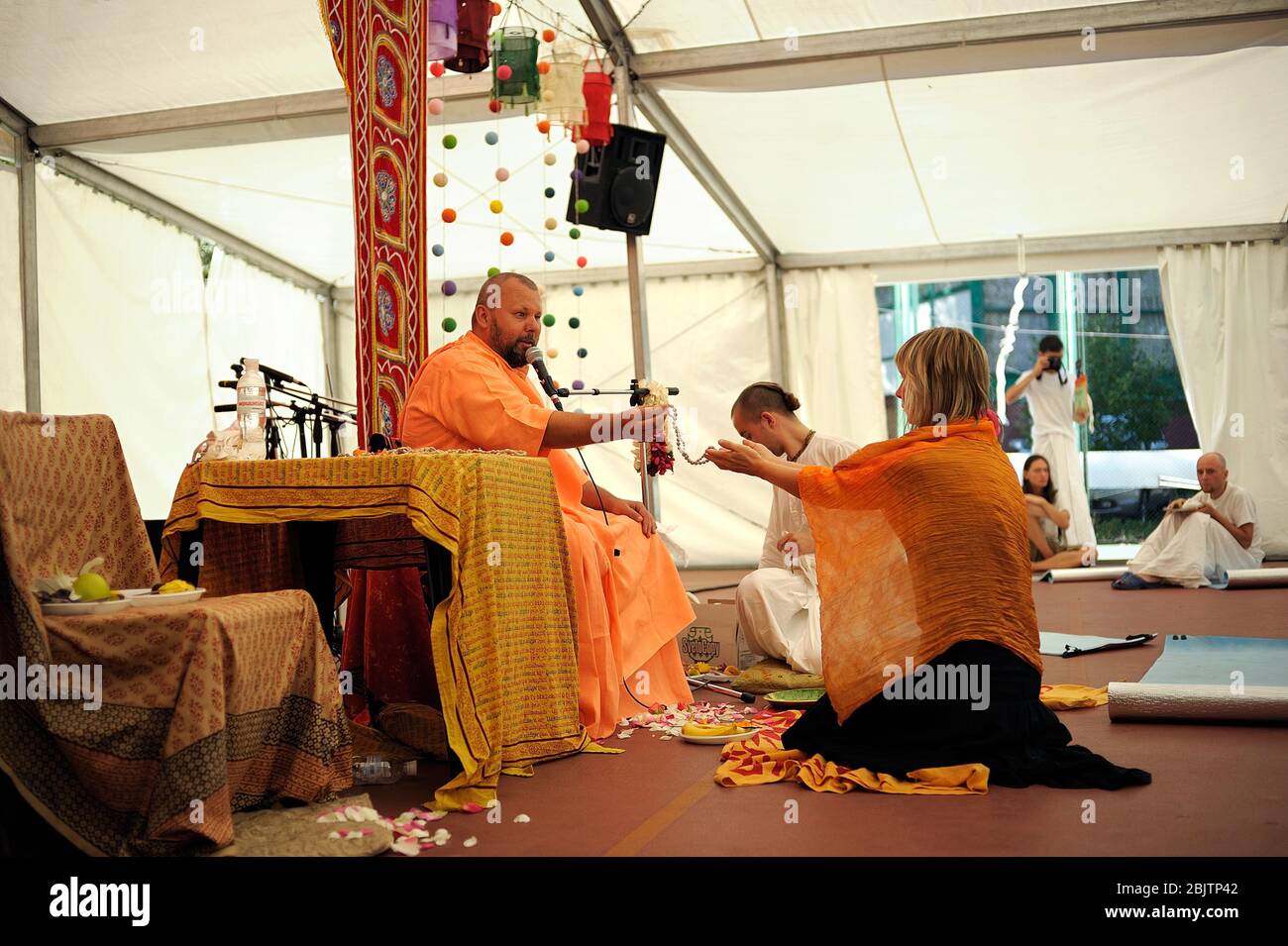 People sitting on the floor and listening to guru preaching during ...