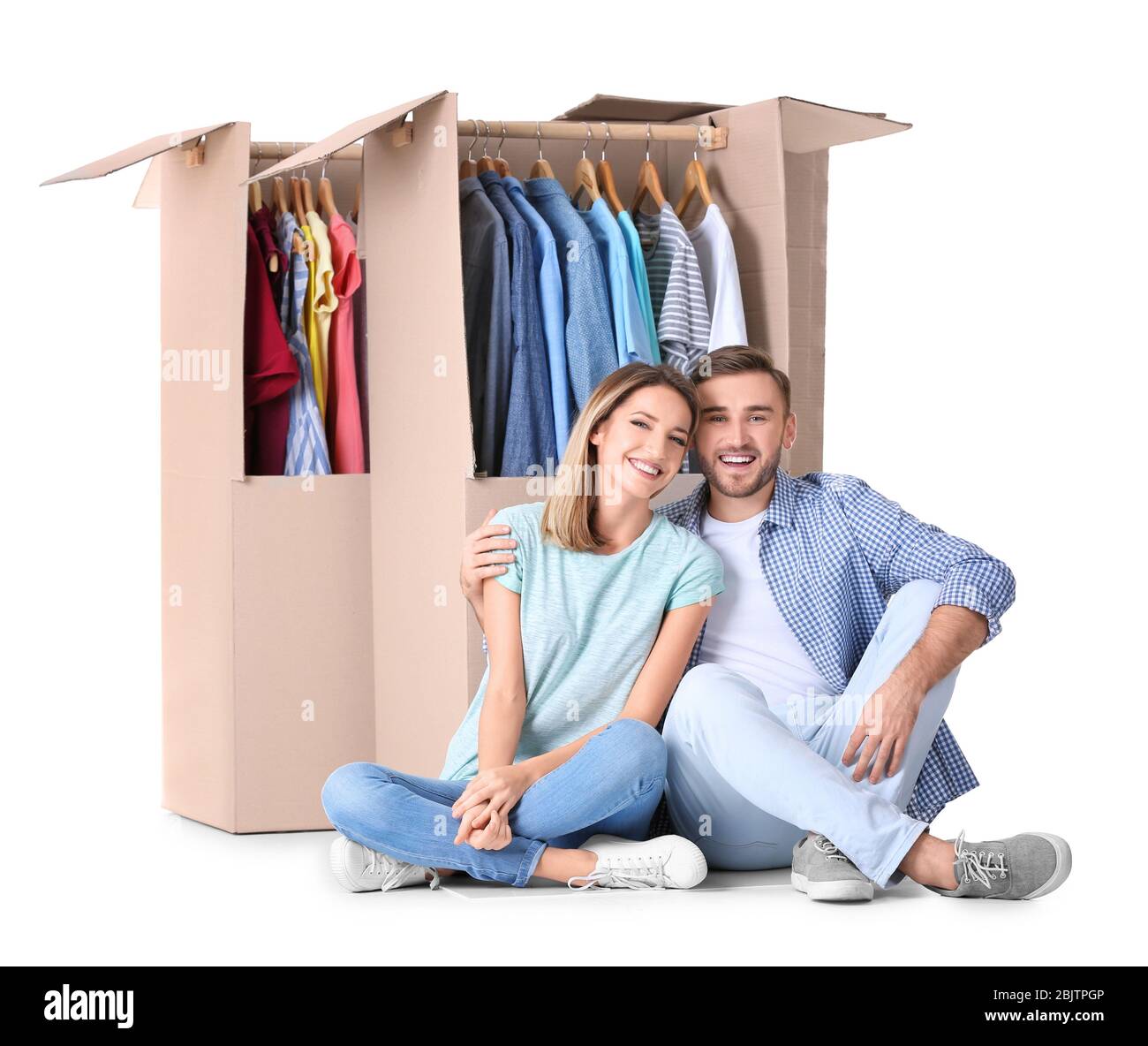 Young couple near wardrobe boxes on white background Stock Photo - Alamy