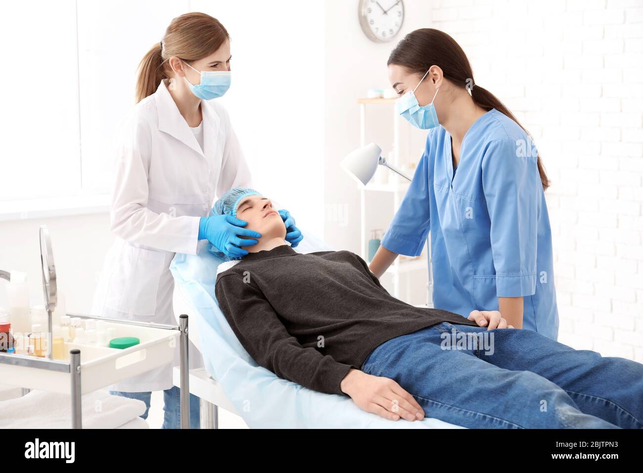 Professional beautician teaching trainee in salon. Apprenticeship ...