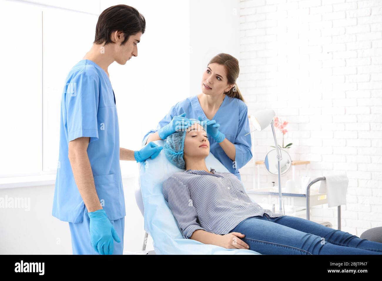 Professional beautician teaching trainee in salon. Apprenticeship ...