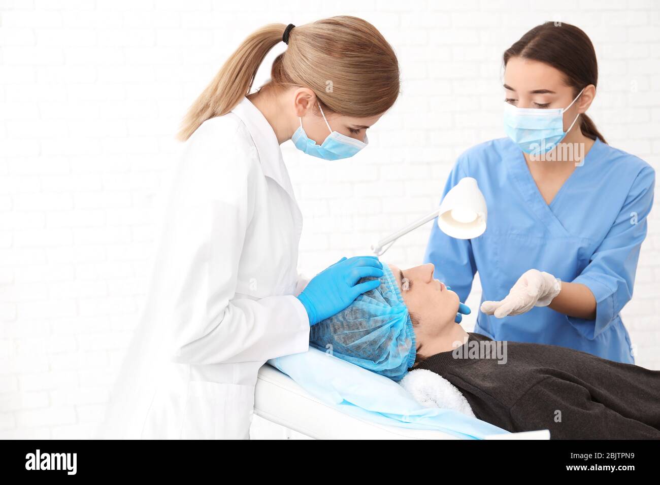 Professional beautician teaching trainee in salon. Apprenticeship ...