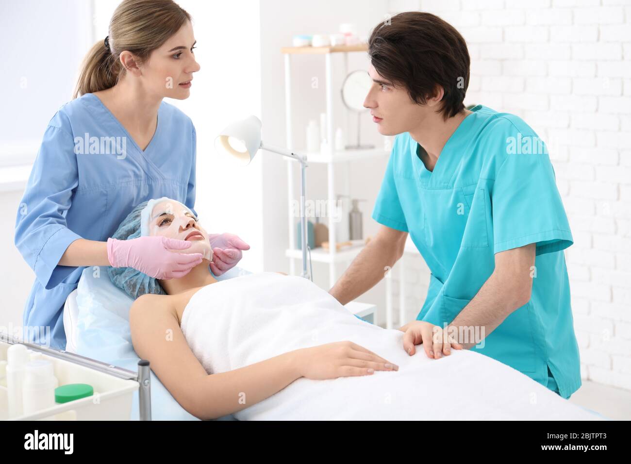 Professional beautician teaching trainee in salon. Apprenticeship ...