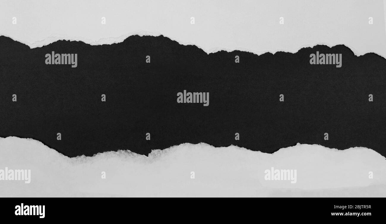 Ripped paper on black background Stock Photo - Alamy