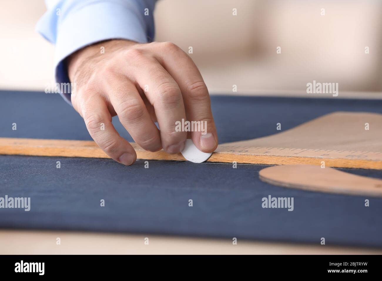 Tailor marking fabric with chalk in atelier Stock Photo - Alamy