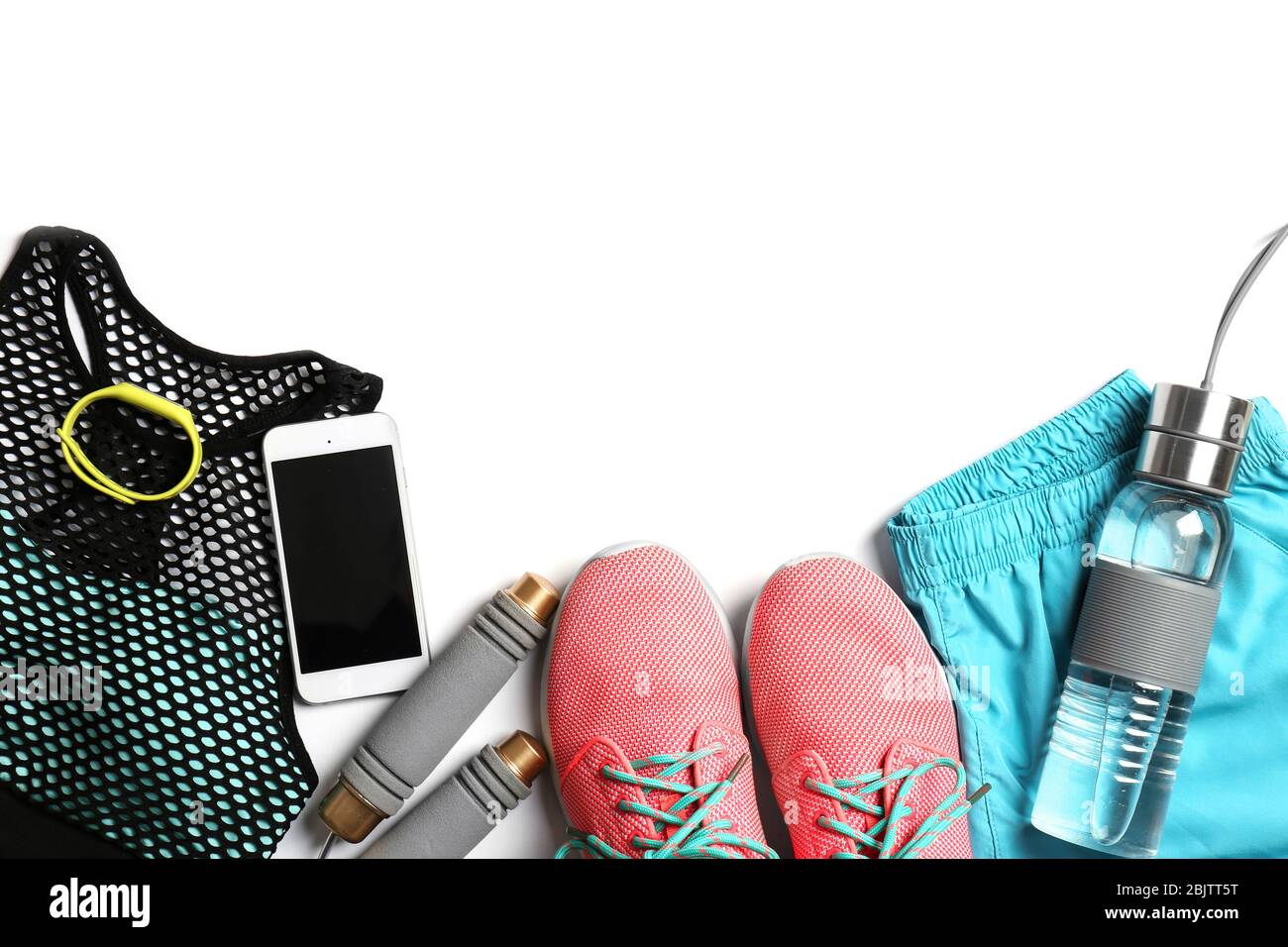 Gym stuff, mobile phone and blank space for exercise plan on white ...