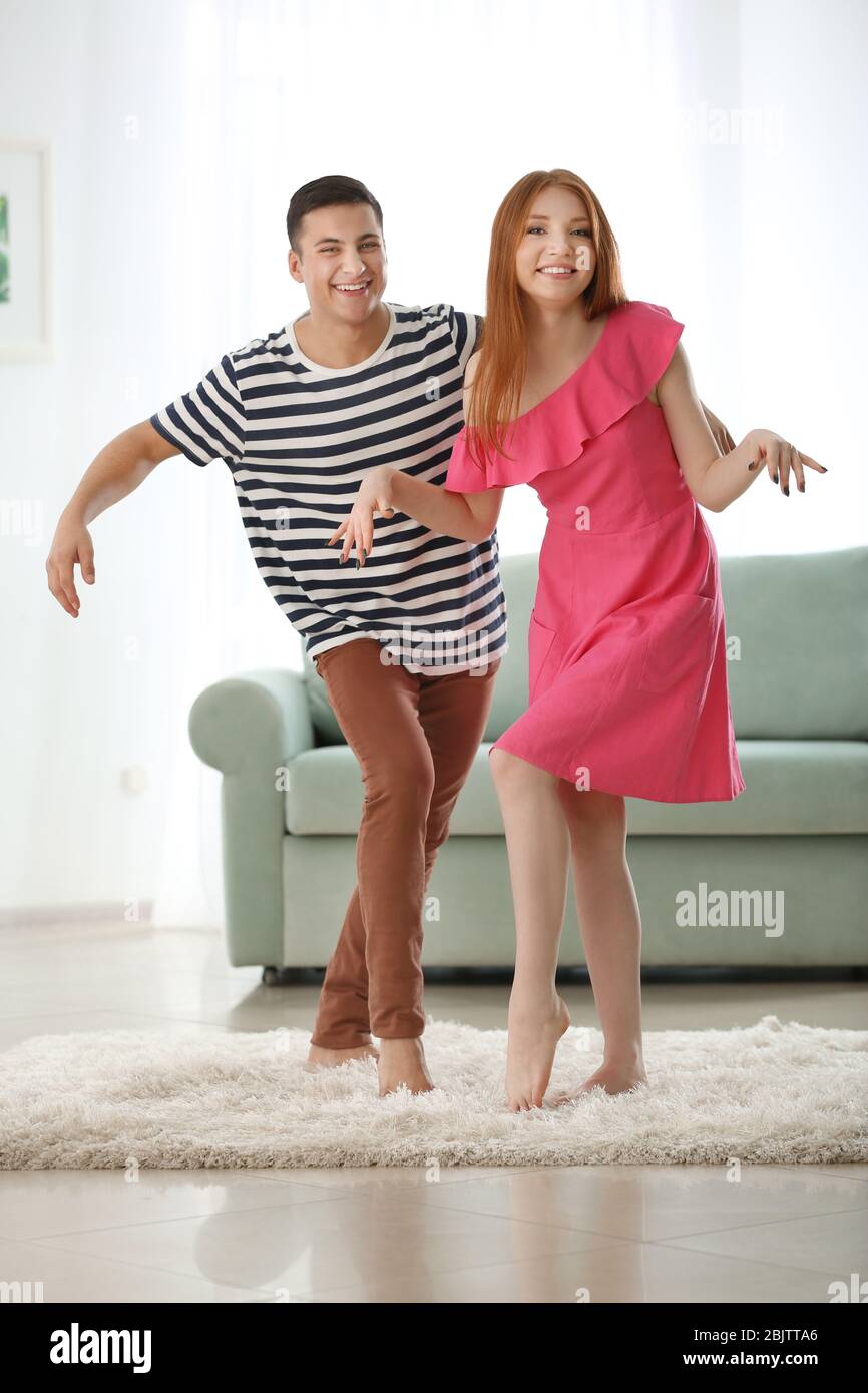 Cute young couple dancing at home Stock Photo - Alamy