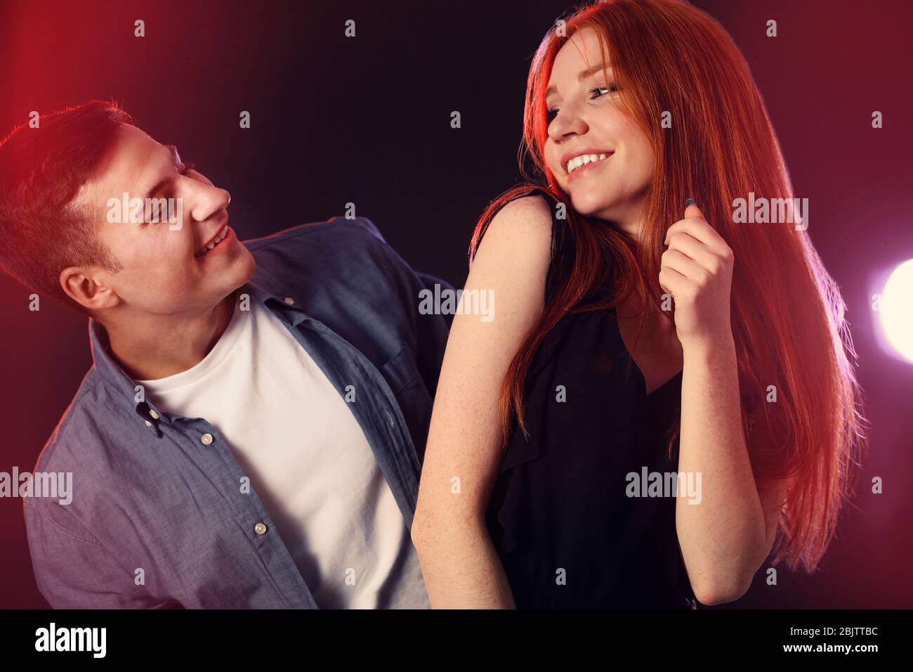 Cute young couple dancing in night club Stock Photo - Alamy