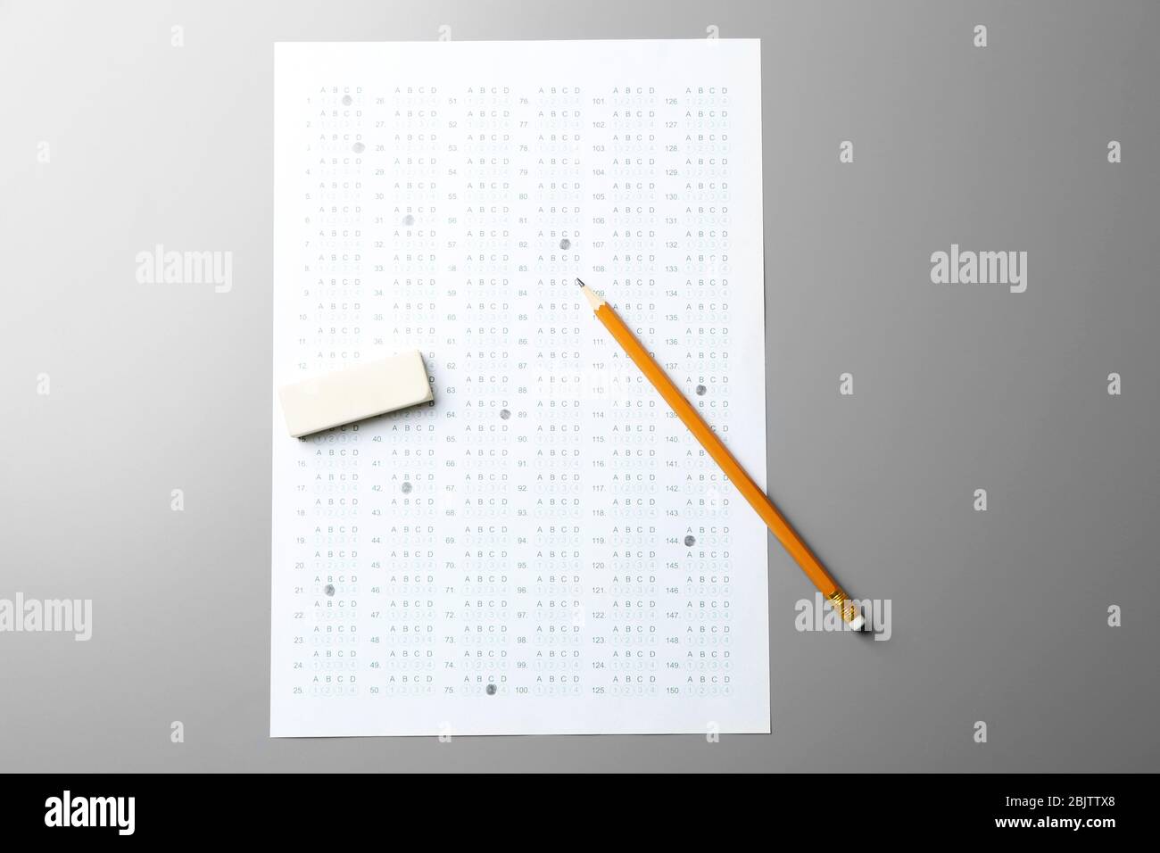 Exam form, pencil and eraser on table Stock Photo - Alamy