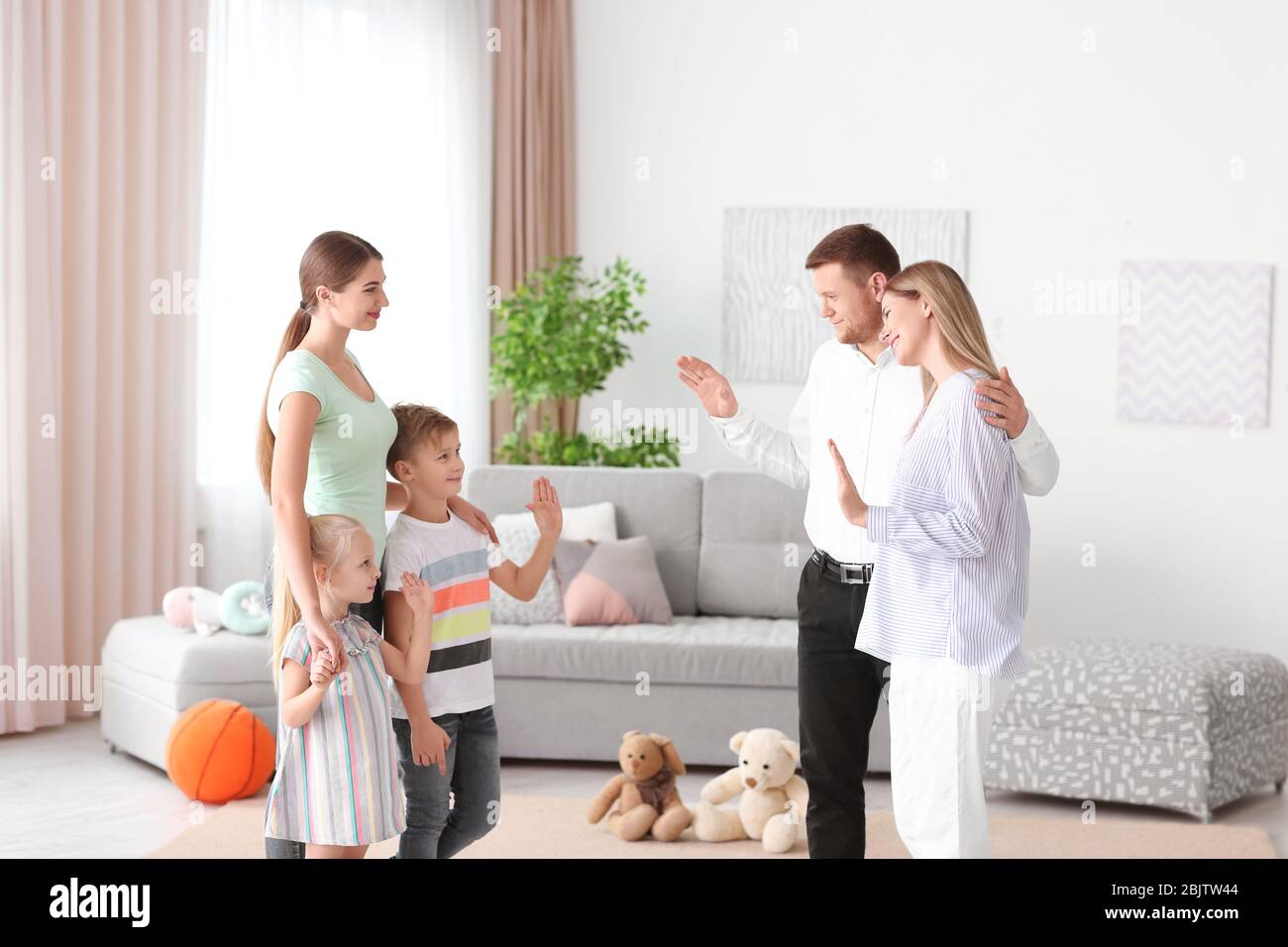 Parents leaving their children with nanny at home Stock Photo - Alamy