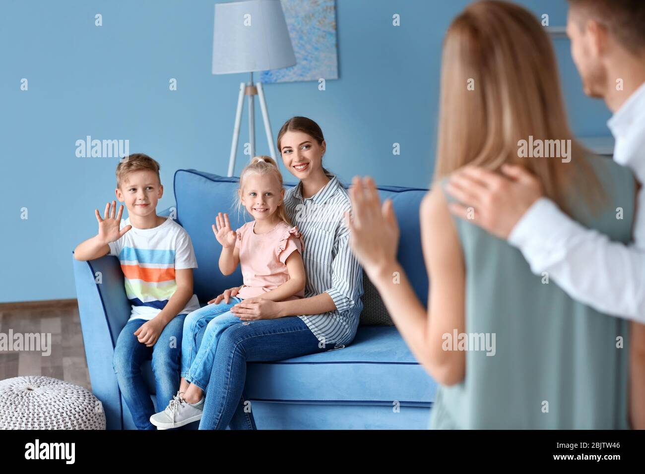 Parents leaving their children with nanny at home Stock Photo - Alamy