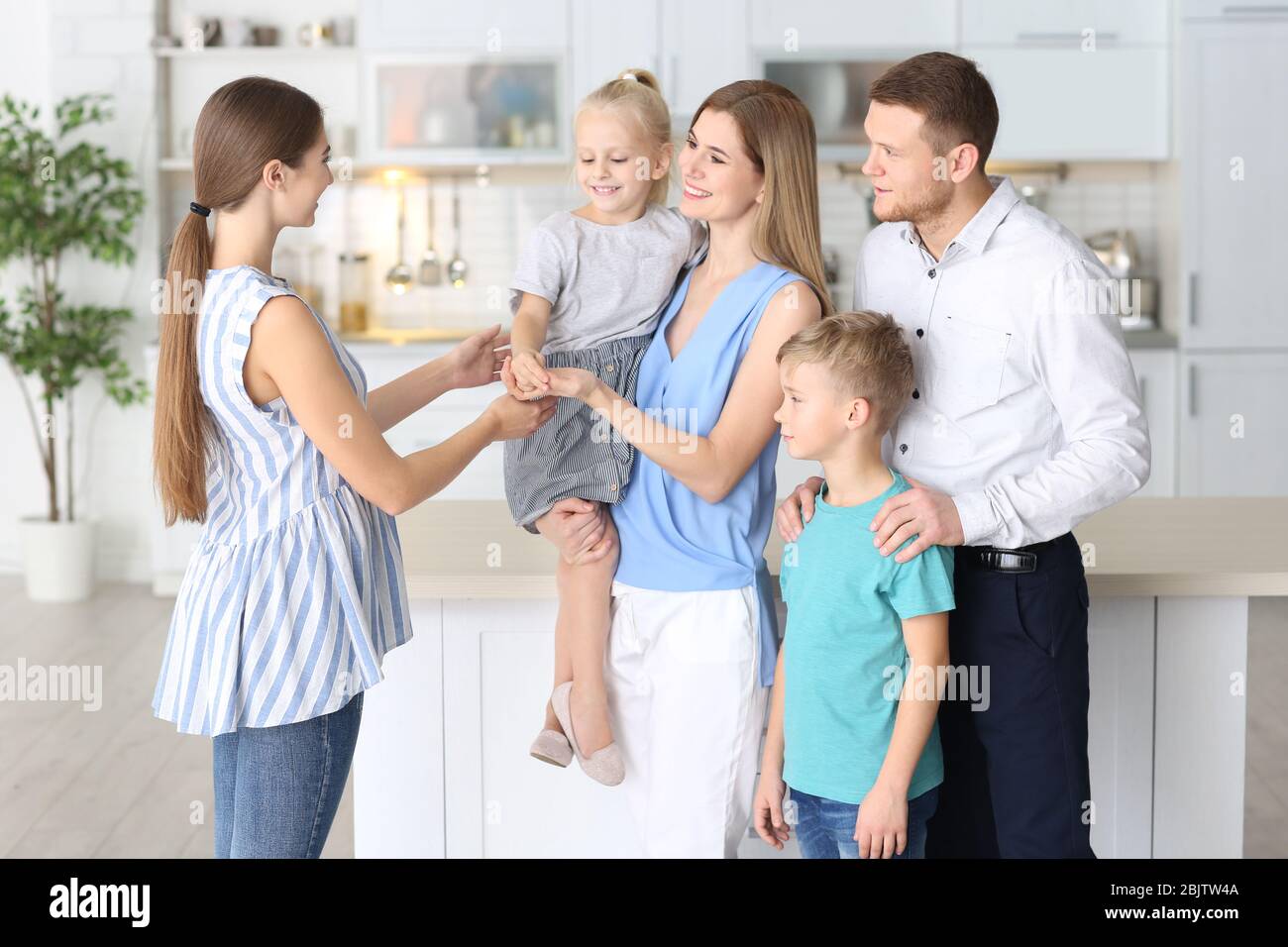 Parents leaving their children with nanny at home Stock Photo - Alamy