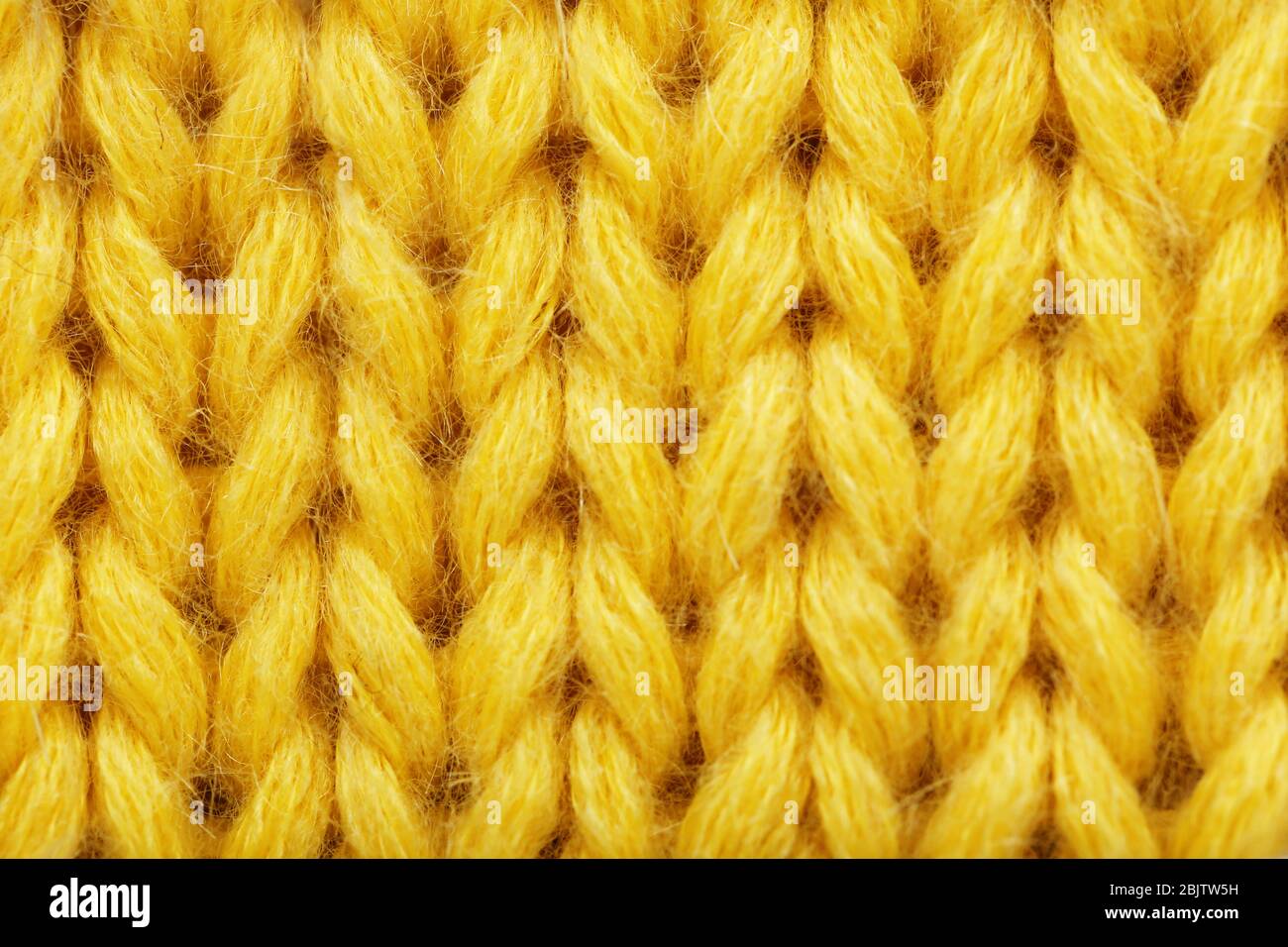Yellow knitted fabric texture as background, closeup Stock Photo - Alamy