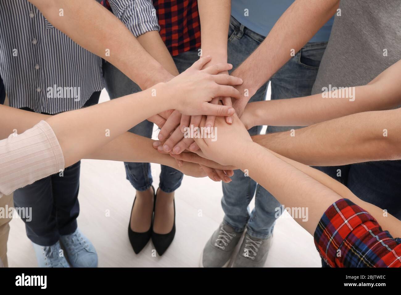 Young people putting hands together as symbol of unity Stock Photo - Alamy