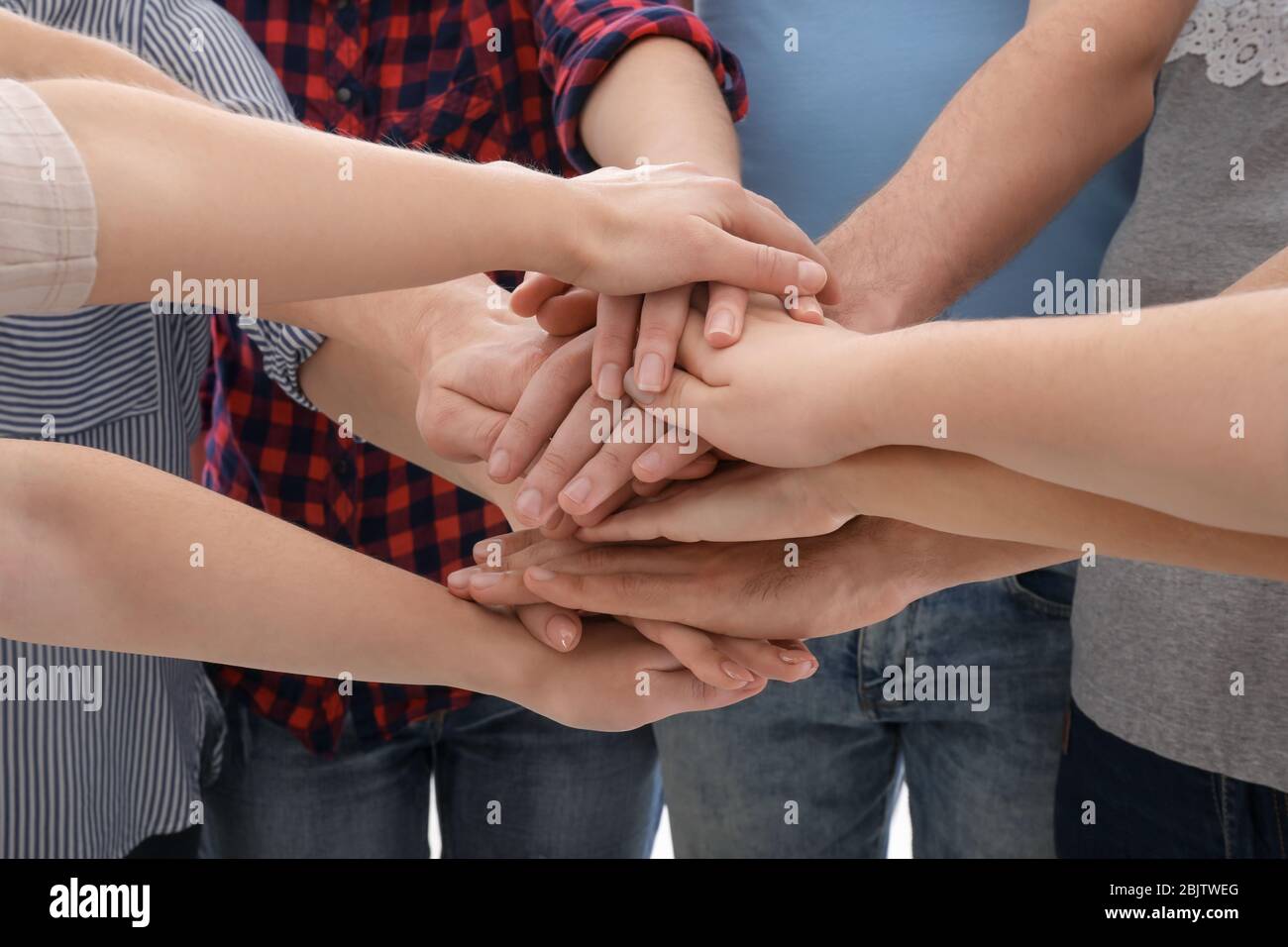 Young people putting hands together as symbol of unity, closeup Stock ...