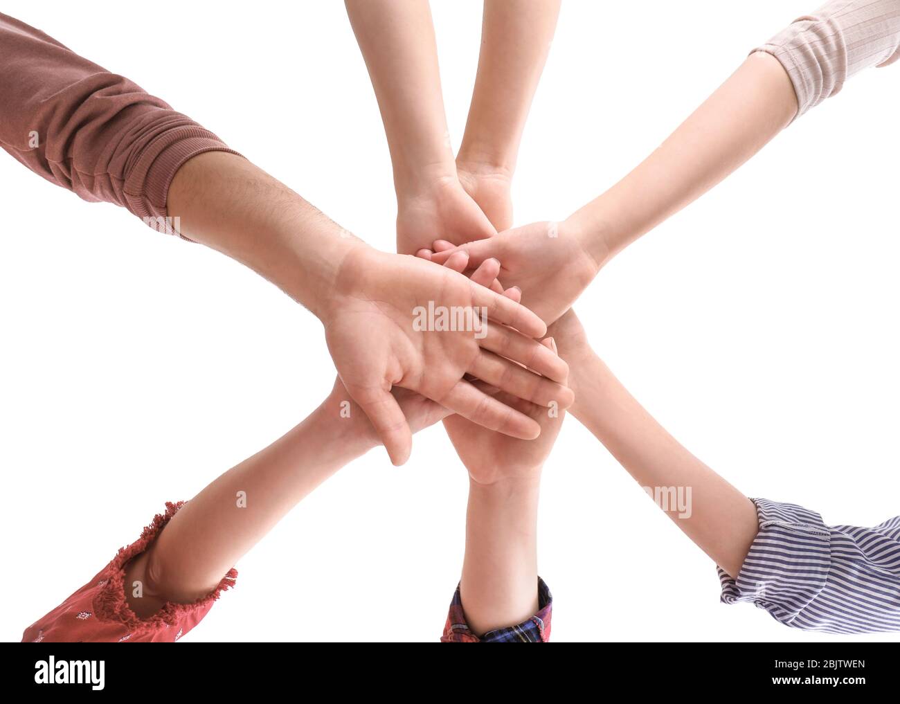 Young people putting hands together as symbol of unity, on white ...