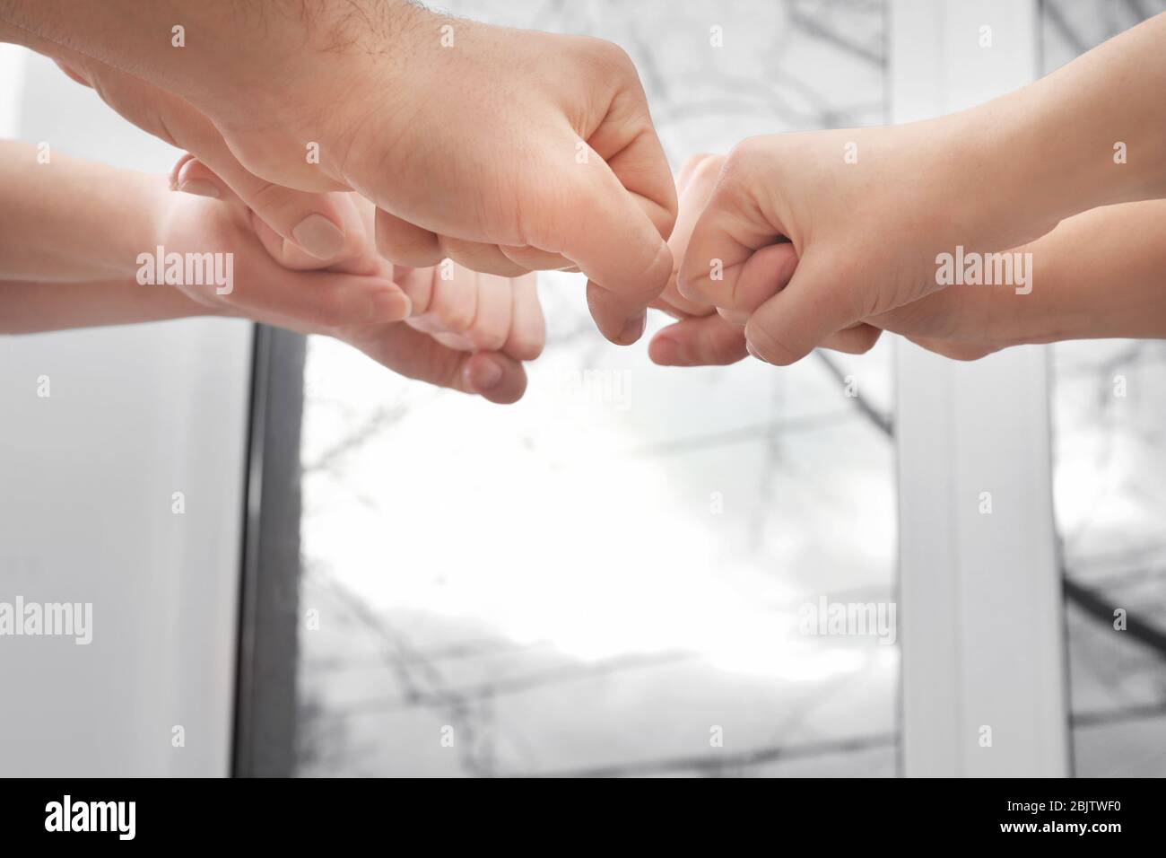 Young people putting their fists together as symbol of unity, closeup ...