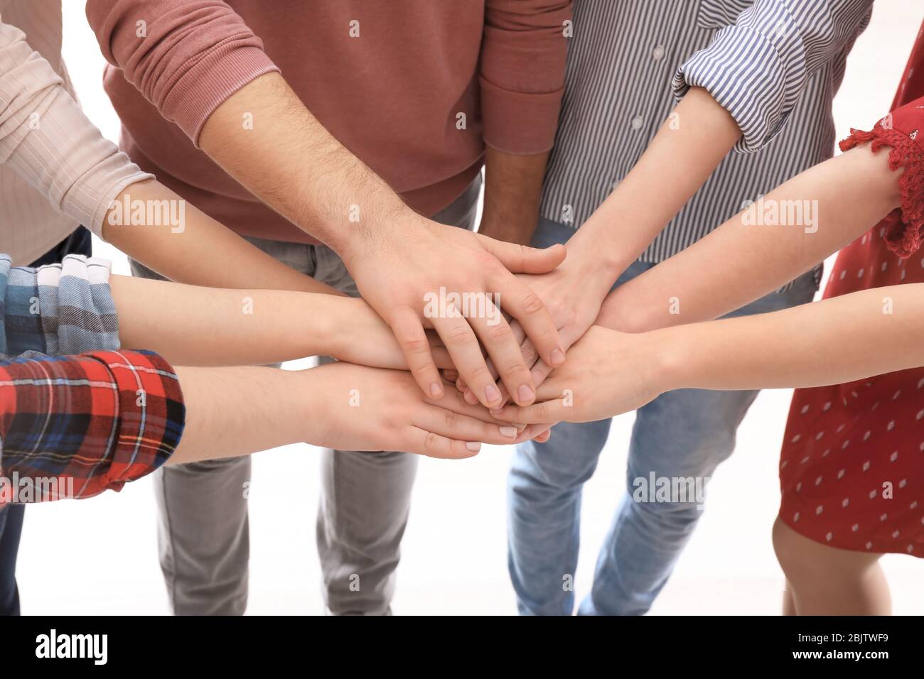 Young people putting hands together as symbol of unity Stock Photo - Alamy