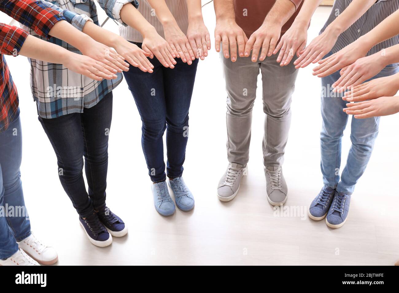 Young people putting hands together as symbol of unity Stock Photo - Alamy