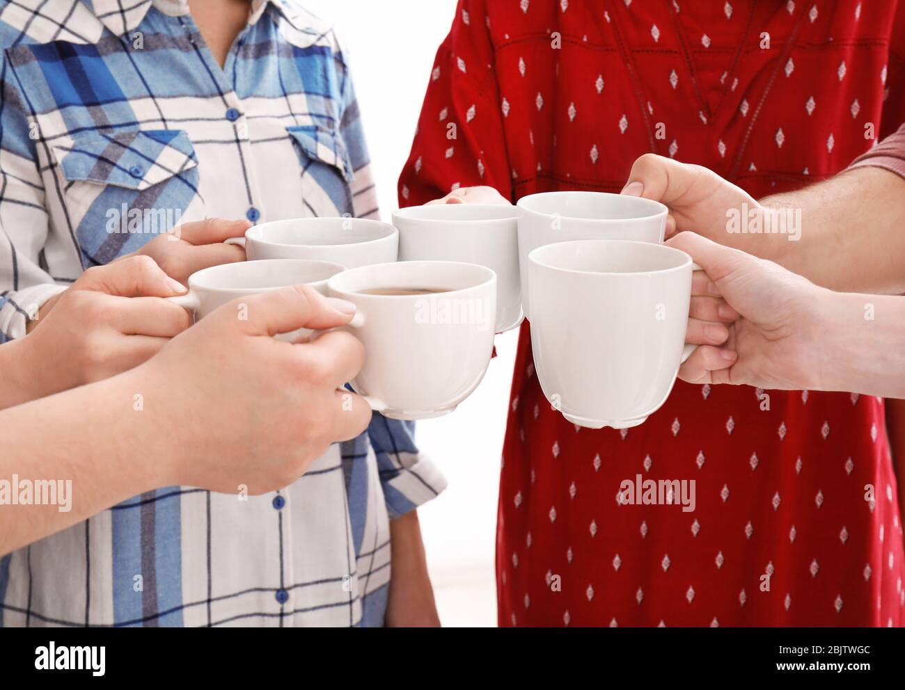 Group of people drinking tea together. Unity concept Stock Photo - Alamy