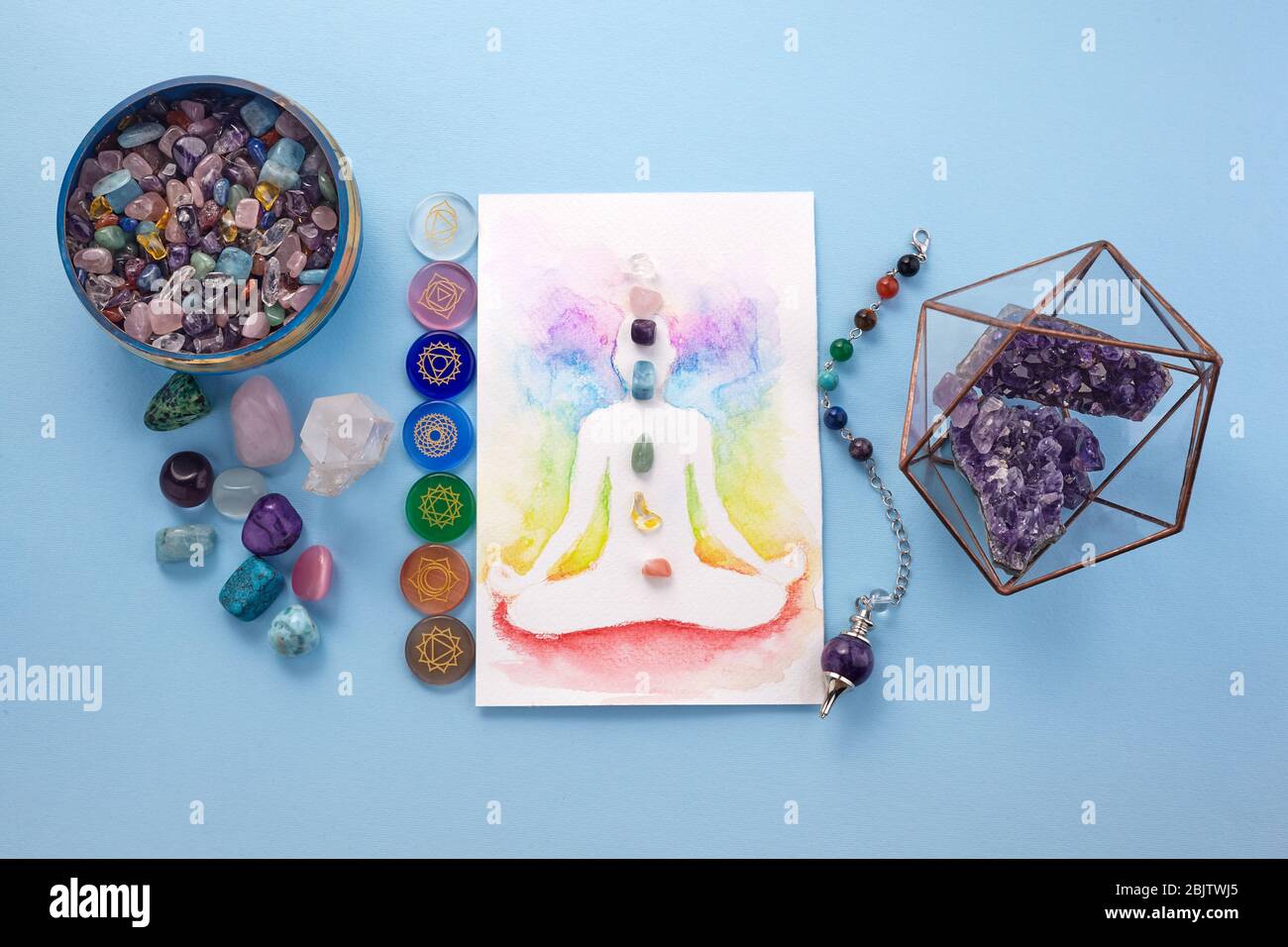 Natural crystals and pendulum on pastel silk background. Reiki ...